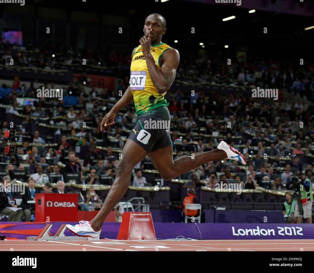 Jamaica's Usain Bolt gestures as he crosses the finish line to win gold ...