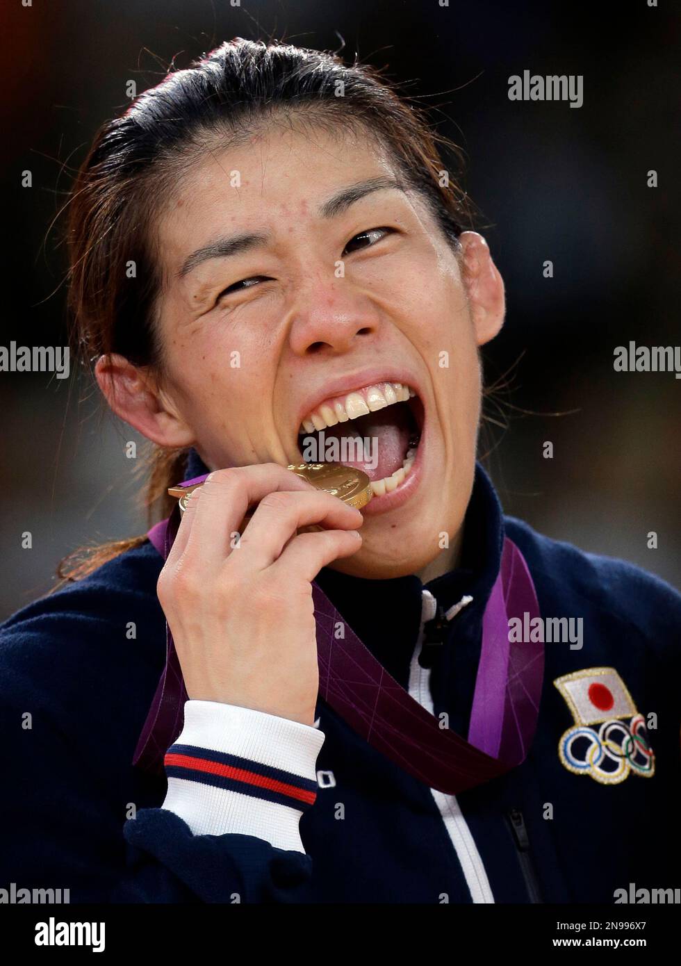 Gold medalist Saori Yoshida of Japan bites her medal after the victory ...