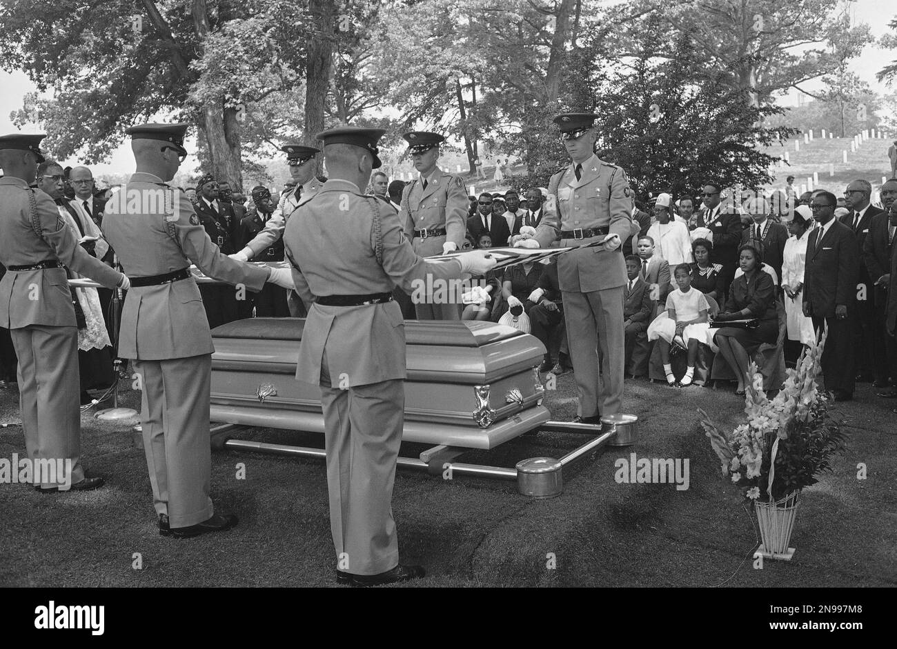 Soldiers hold an American flag above the casket of slain integration leader Medgar Evers during ...