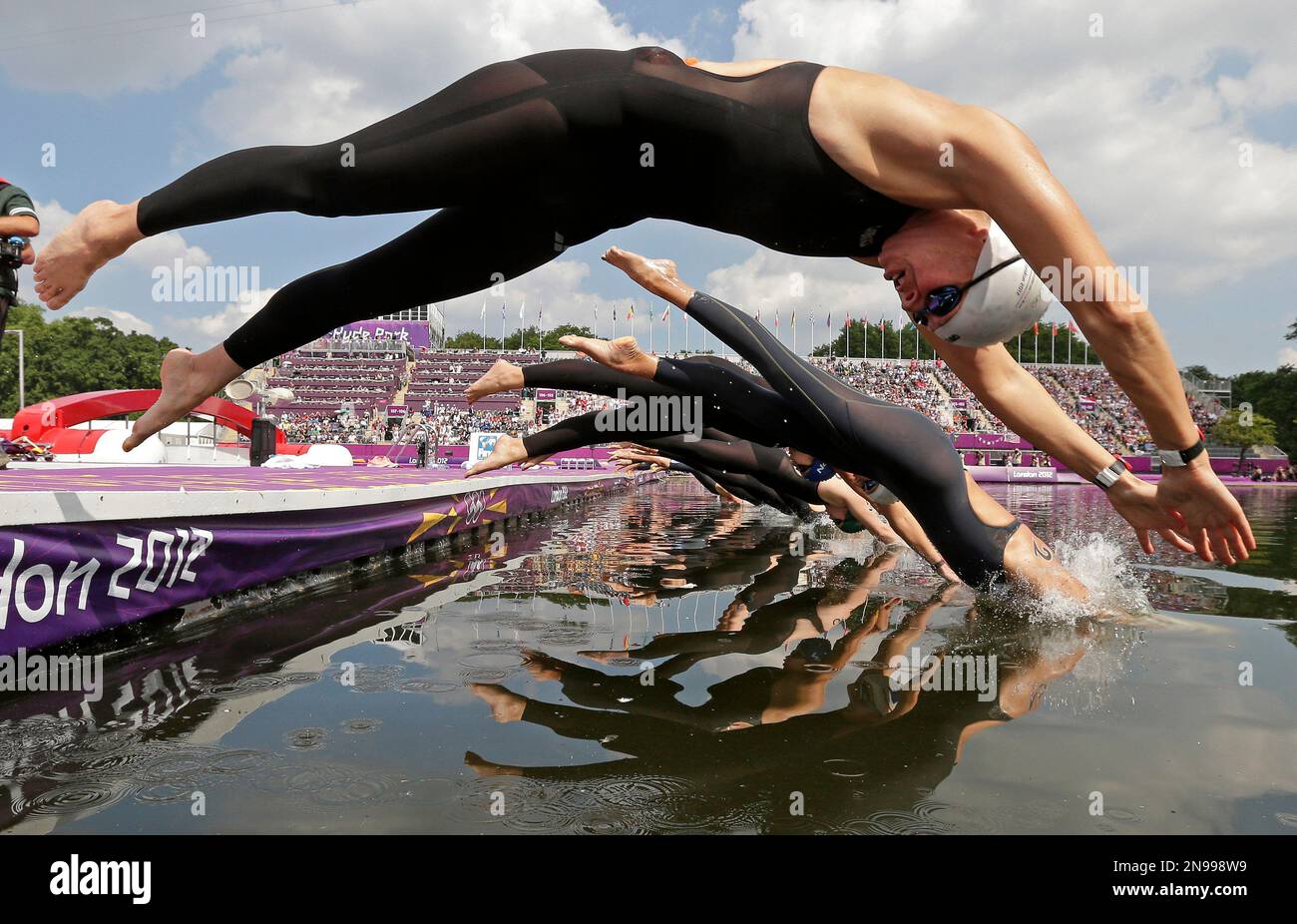 Germany's Angela Maurer, front, and other athletes dive into the ...