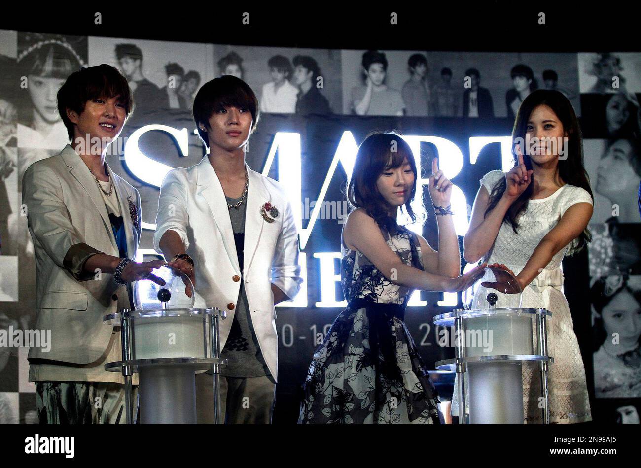 Members of South Korean groups SHINee, left, and Girls' Generation pose ...