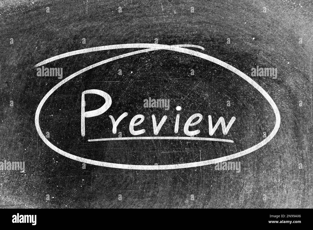 White chalk hand writing in word preview and circle shape on blackboard ...