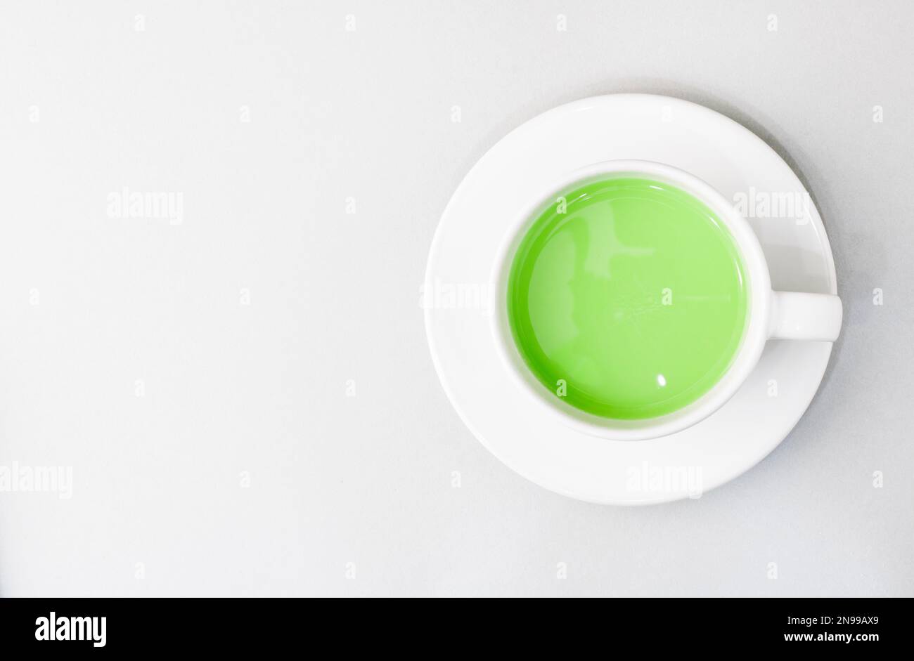 Top view of green tea matcha in a white mug. Matcha ginger latte. Rich ...