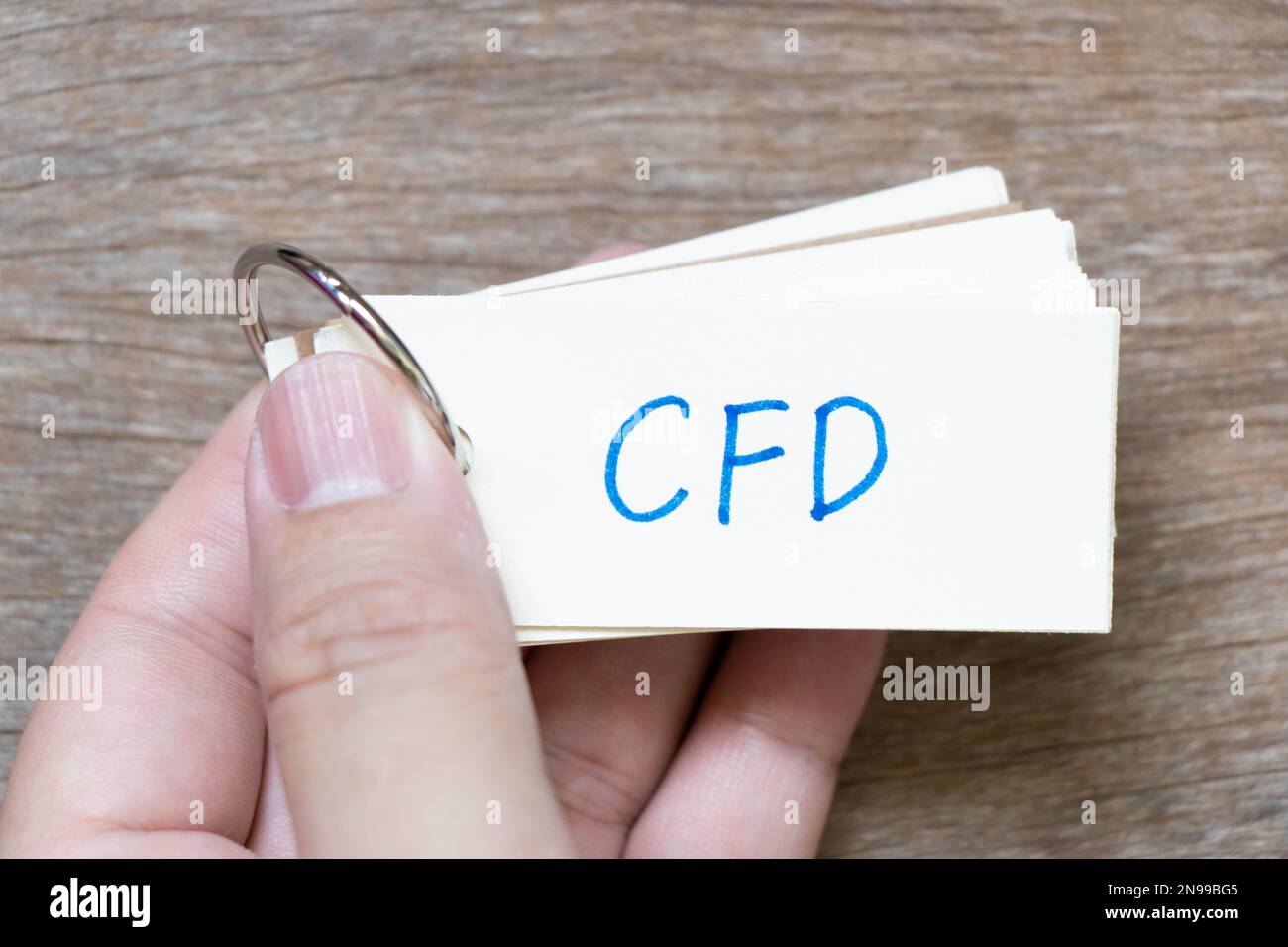Hand hold flash card with handwriting in word CFD (Abbreviation of ...