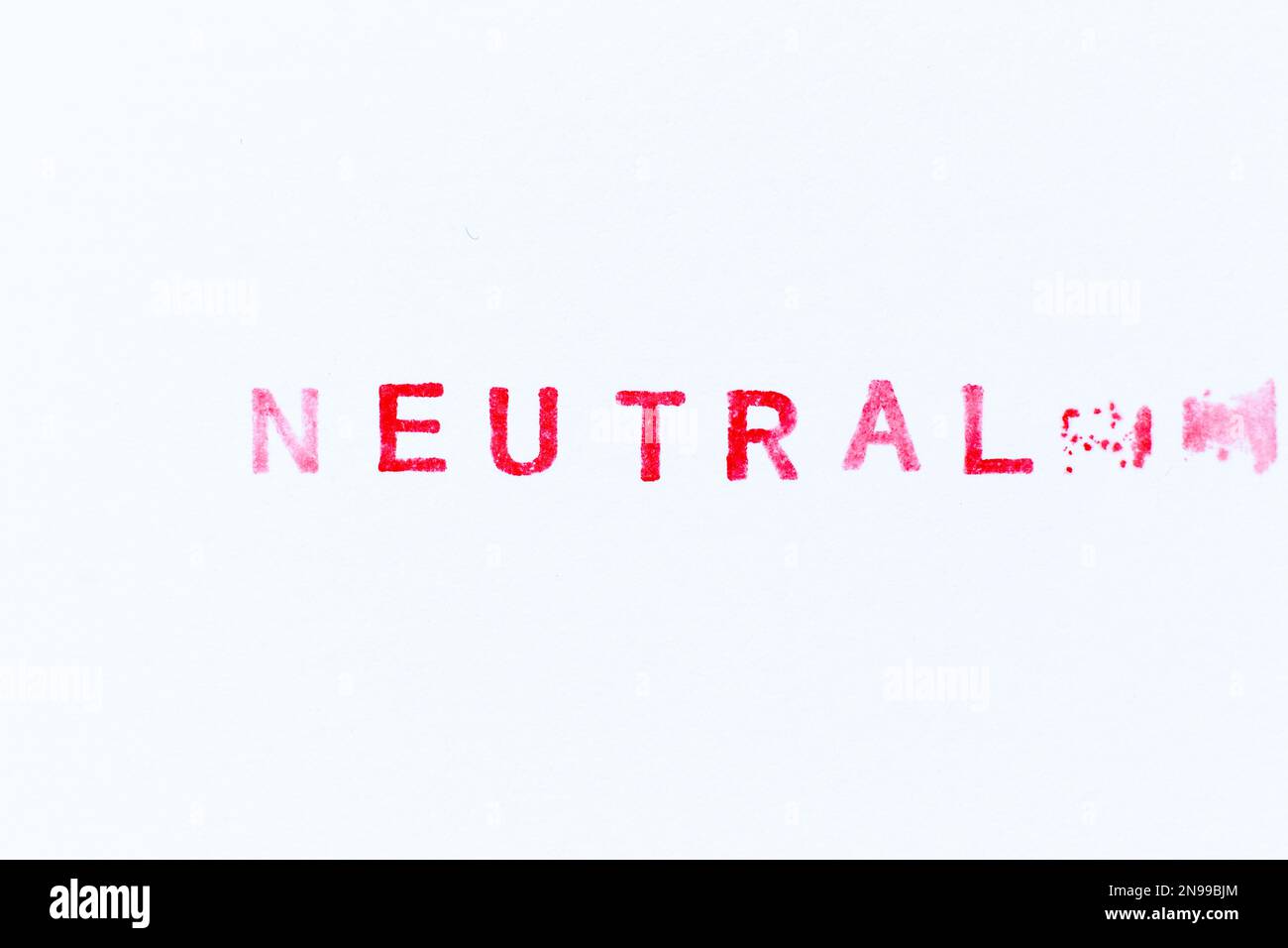 Red color ink rubber stamp in word neutral on white paper background ...