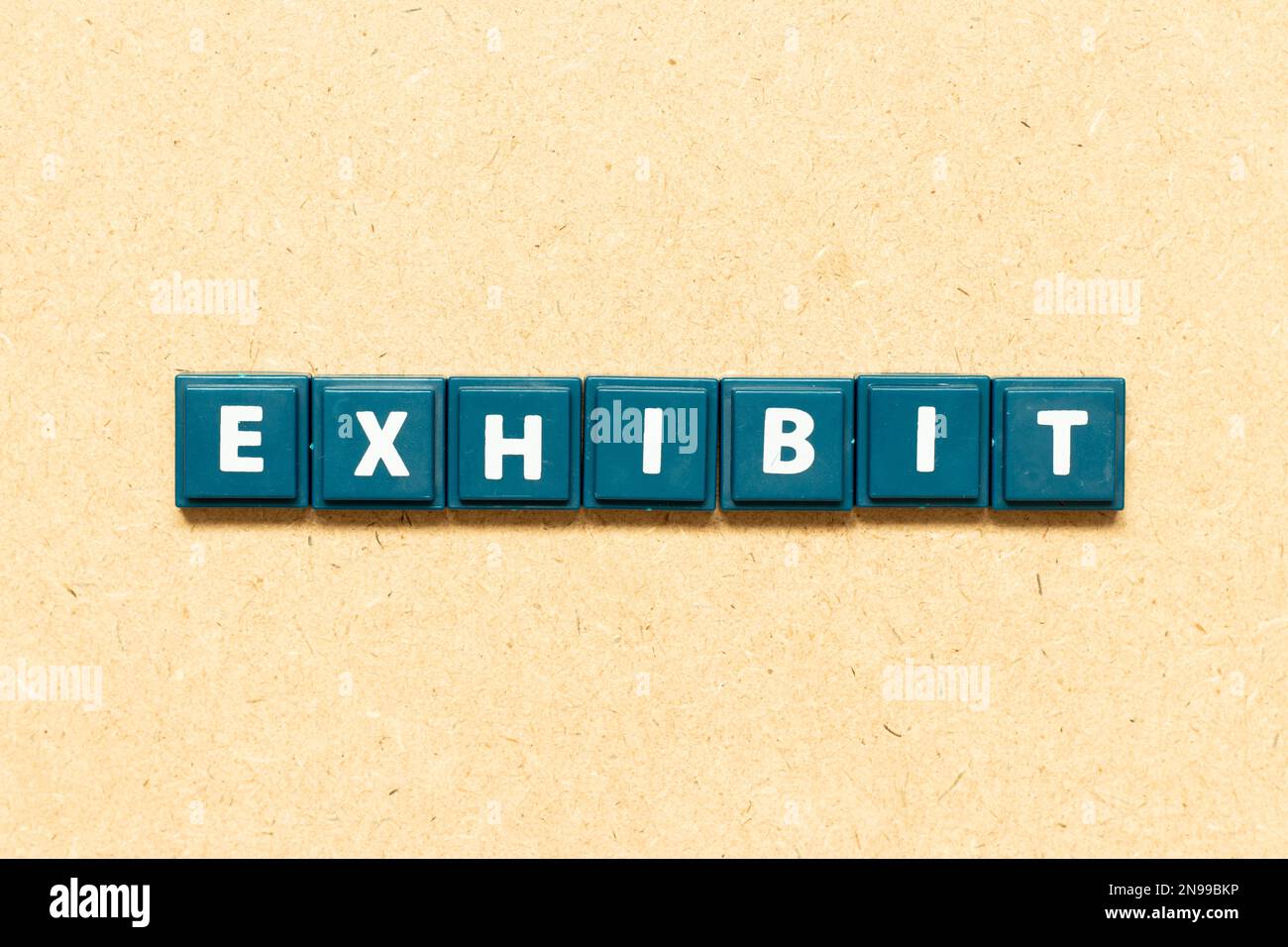 Tile alphabet letter in word exhibit on wood background Stock Photo - Alamy