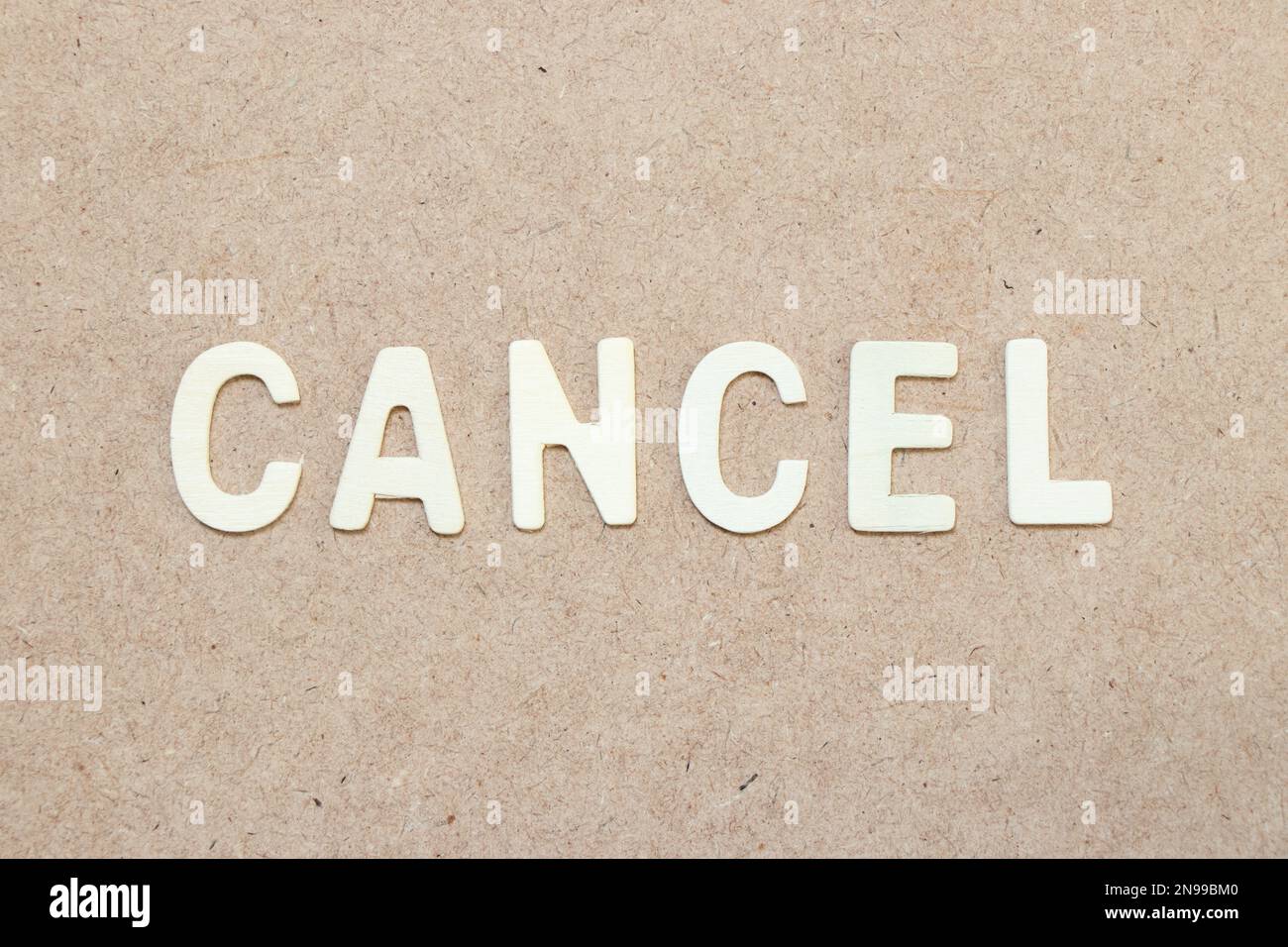 Wood alphabet letter in word cancel on wood background Stock Photo - Alamy