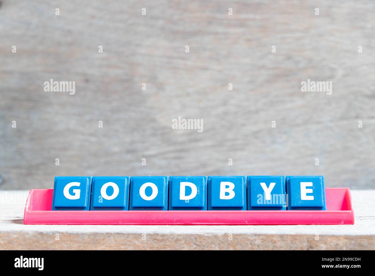 Tile alphabet letter with word goodbye in red color rack on wood ...