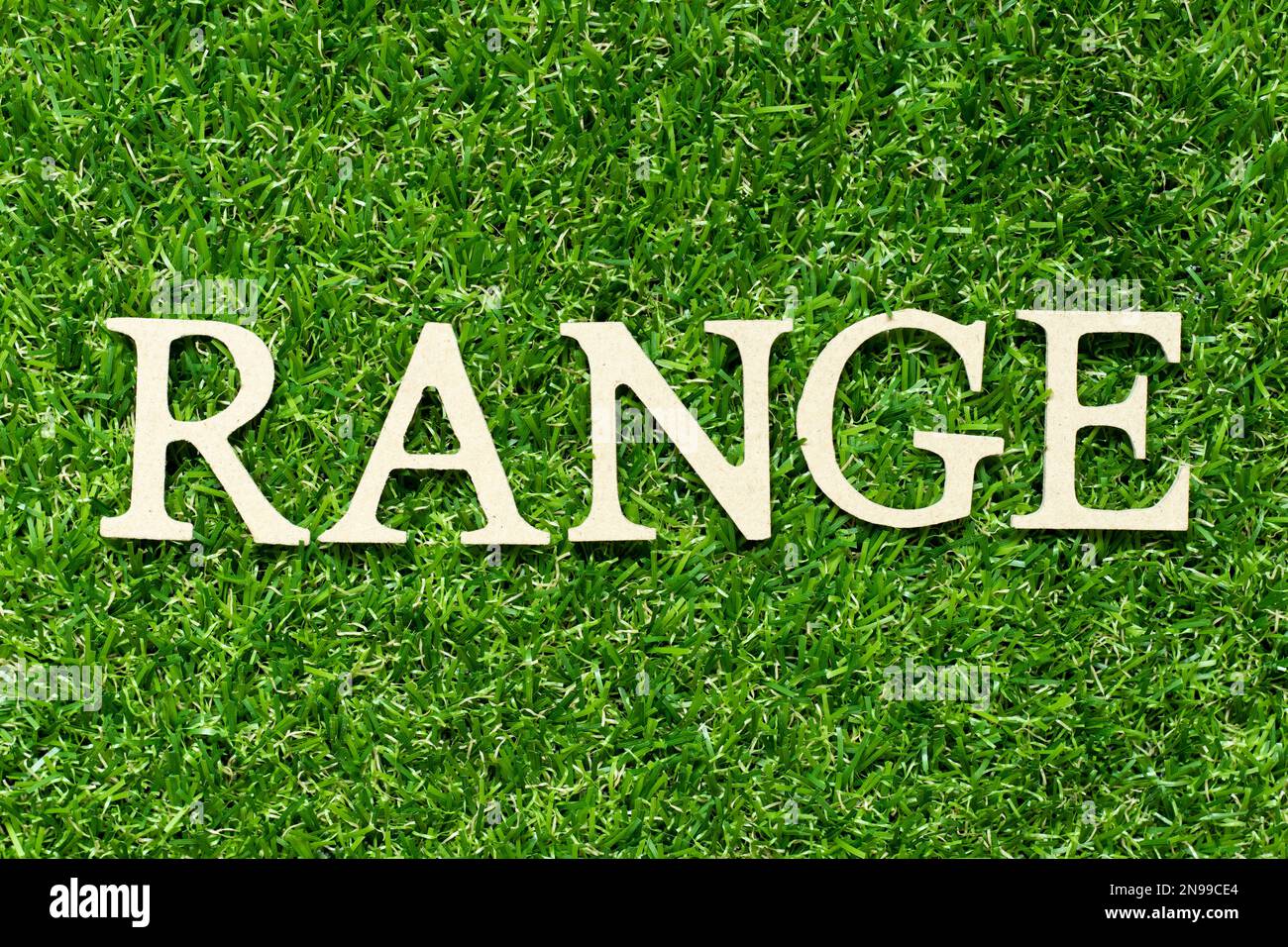 Wood letter in word range on green grass background Stock Photo - Alamy