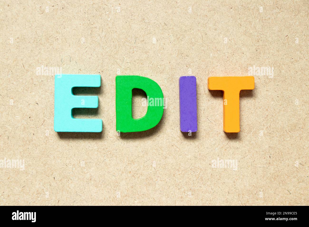 Color alphabet letter in word edit on wood background Stock Photo - Alamy