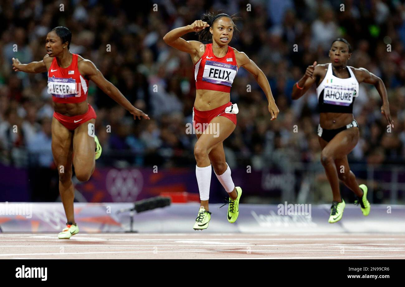 United States' Allyson Felix, center, crosses the finish line to win ...