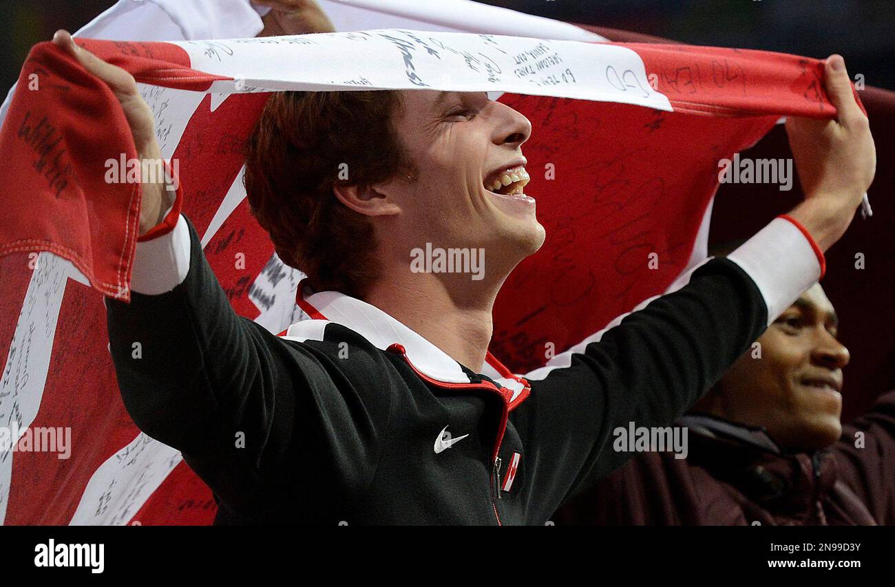 Canada's Derek Drouin wraps himself in the Canadian flag as he ...