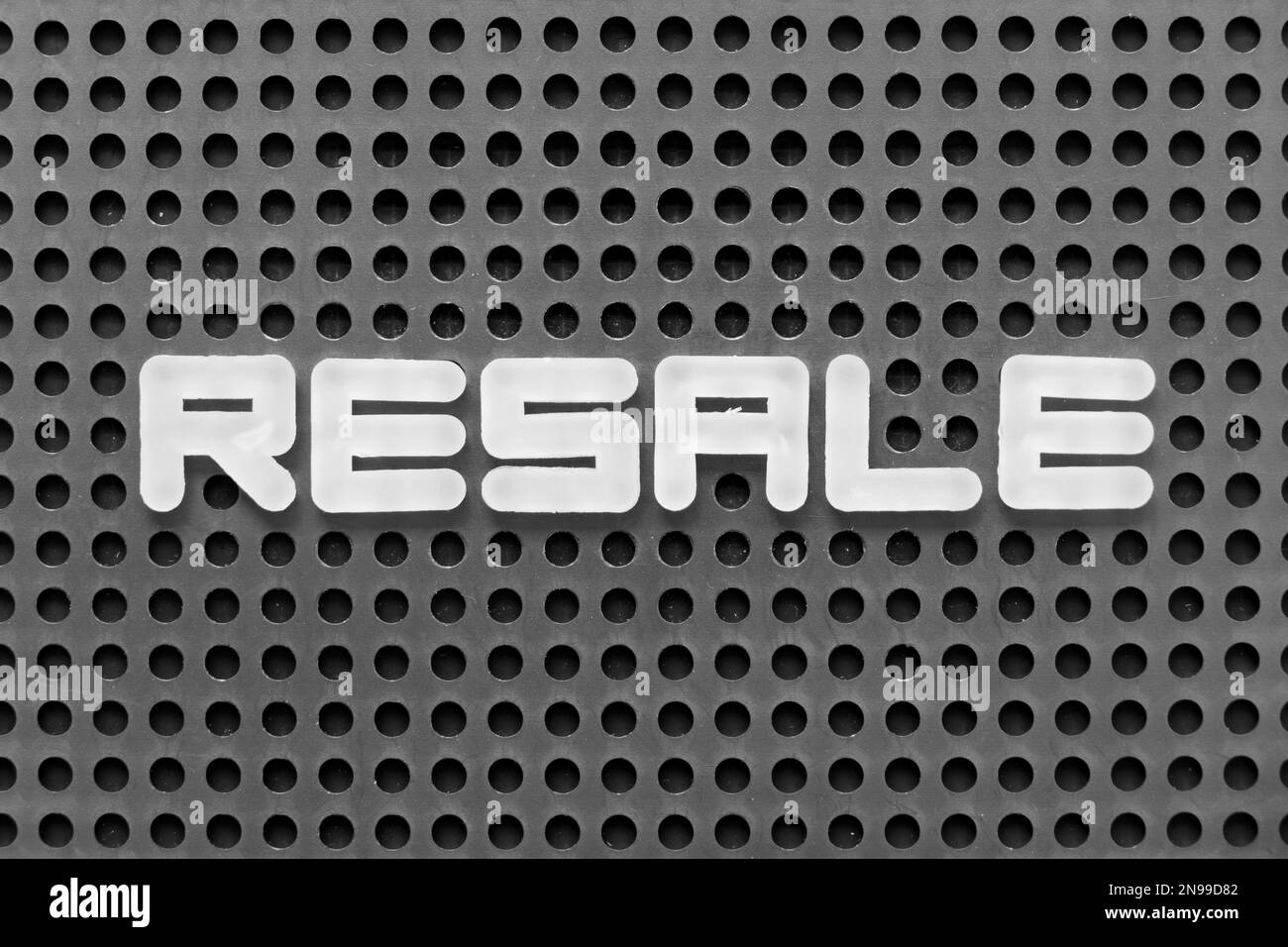 White alphabet letter in word resale on black pegboard background Stock ...