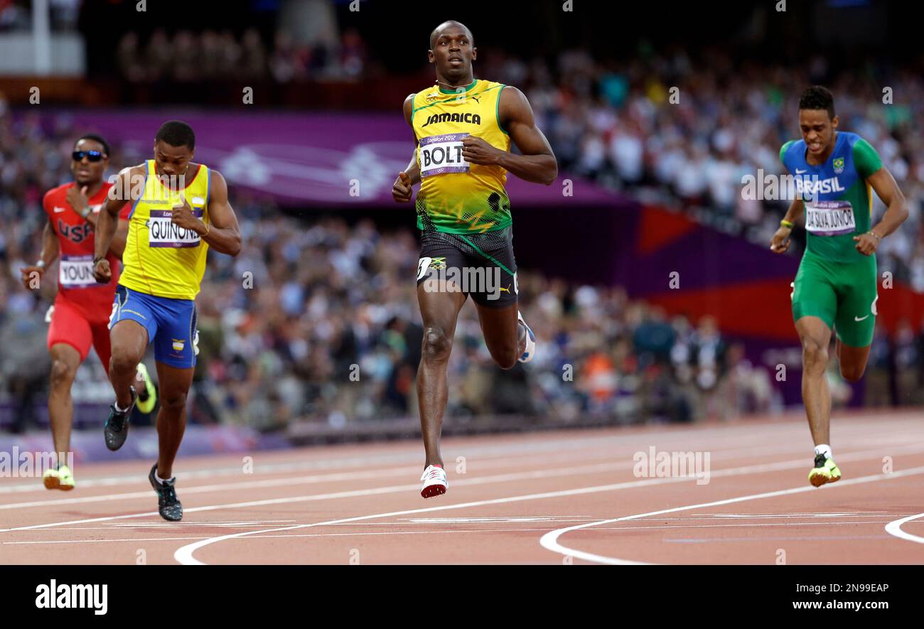 Jamaica's Usain Bolt leads the field across the finish line to win his ...