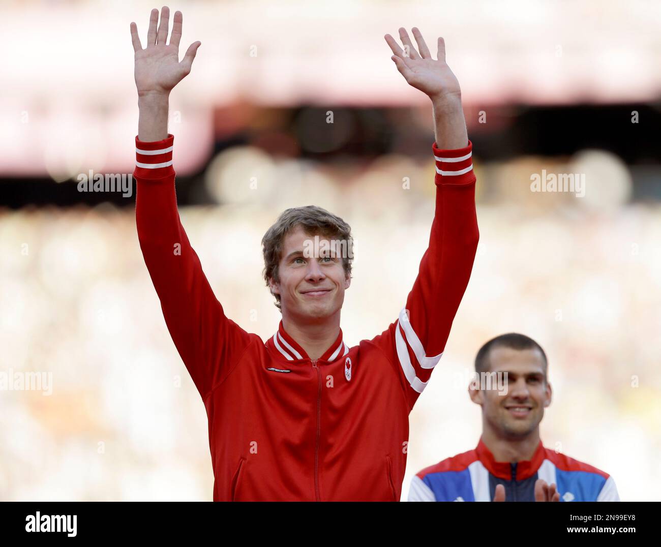 Canada's Derek Drouin, bronze medalist for the men's high jump, waves ...