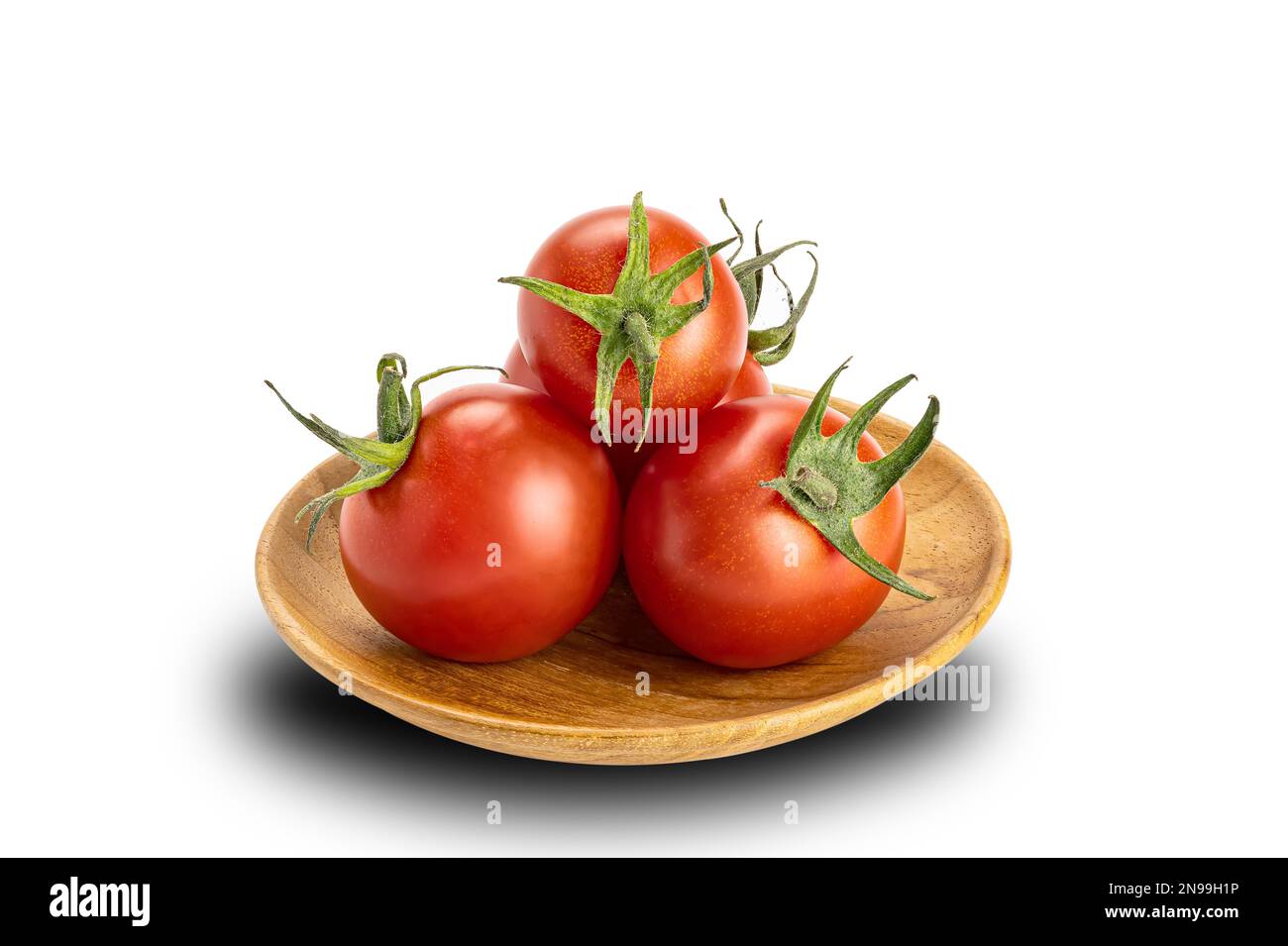 Pile of ripe cherry tomatoes (lycopersicon esculentum) in wooden plate on white background ...