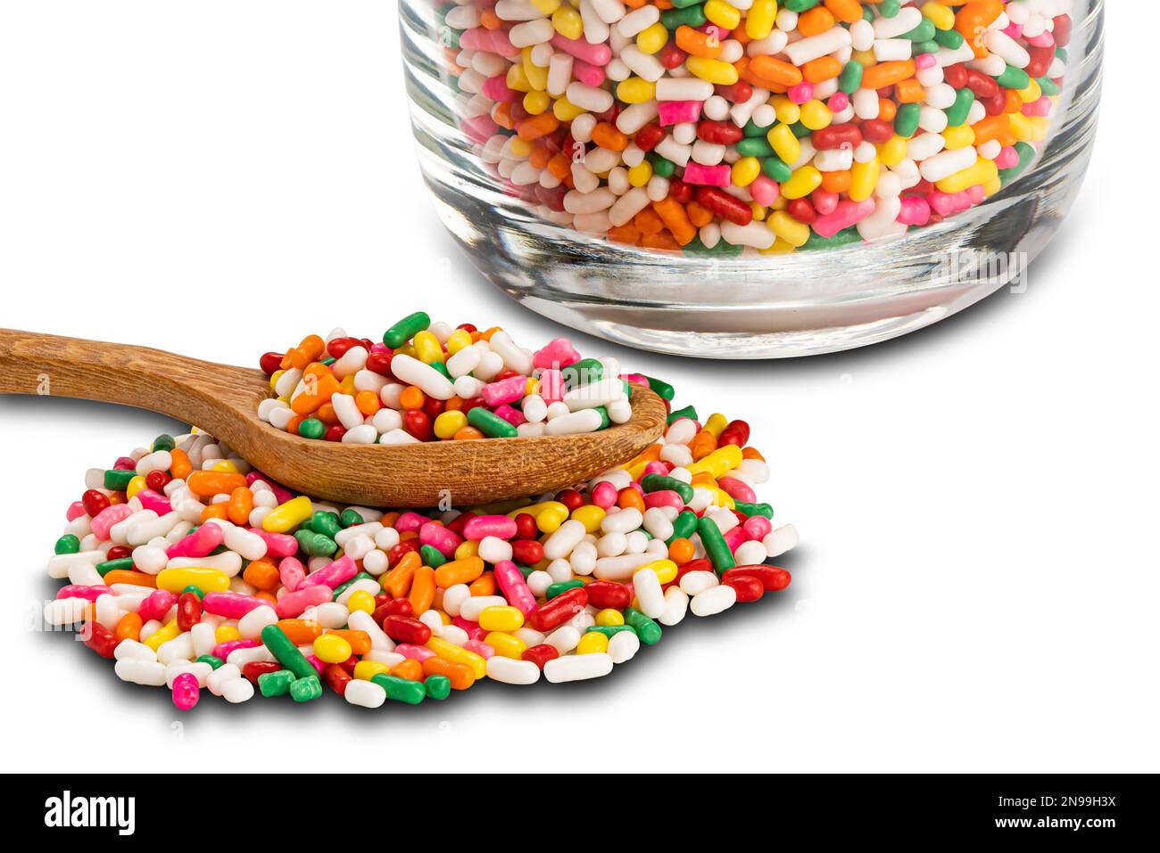Rainbow sprinkles in transparent glass and in wooden spoon isolated on ...