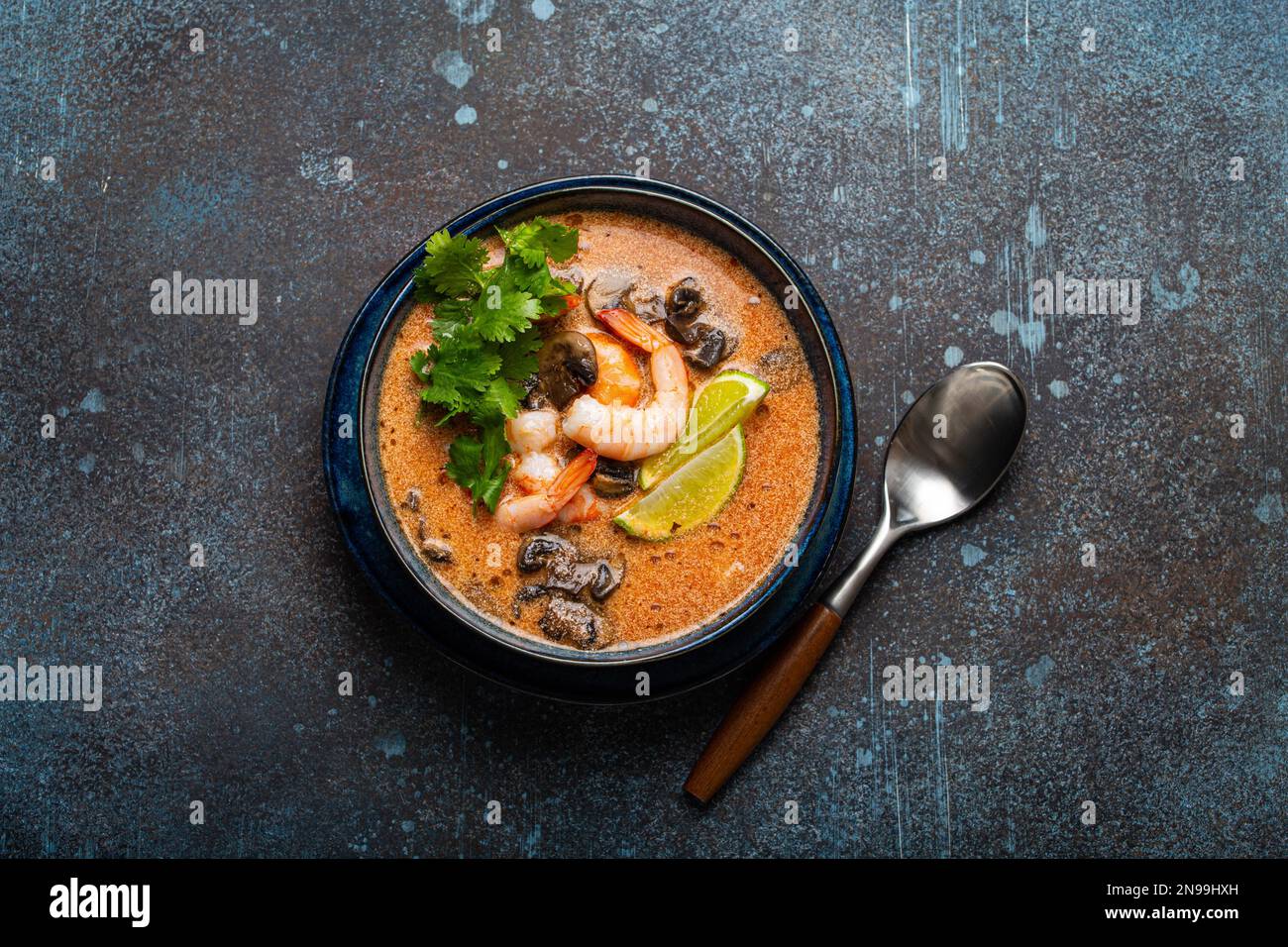 Traditional spicy Thai soup Tom Yum with shrimp and seafood in ceramic ...