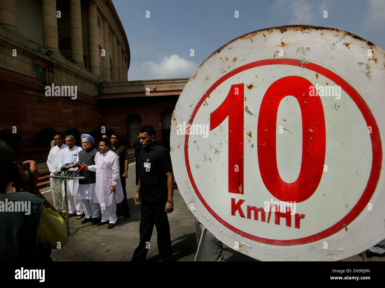 Indian Prime Minister Manmohan Singh, in blue turban, talks to the ...