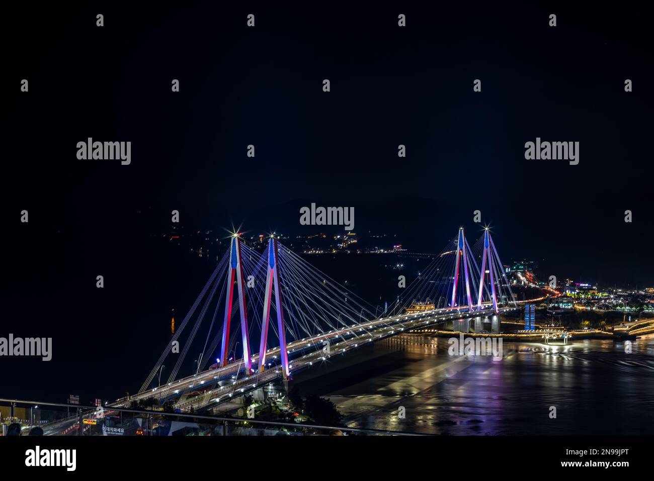 An aerial view of the illuminated Jindo Bridge at night in South Korea ...