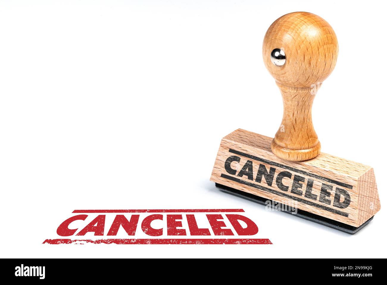 close-up of wooden CANCELED rubber stamp and red imprint isolated on ...