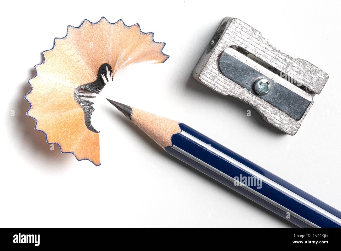 top view of pencil sharpener, pencil and shavings on white desk Stock ...