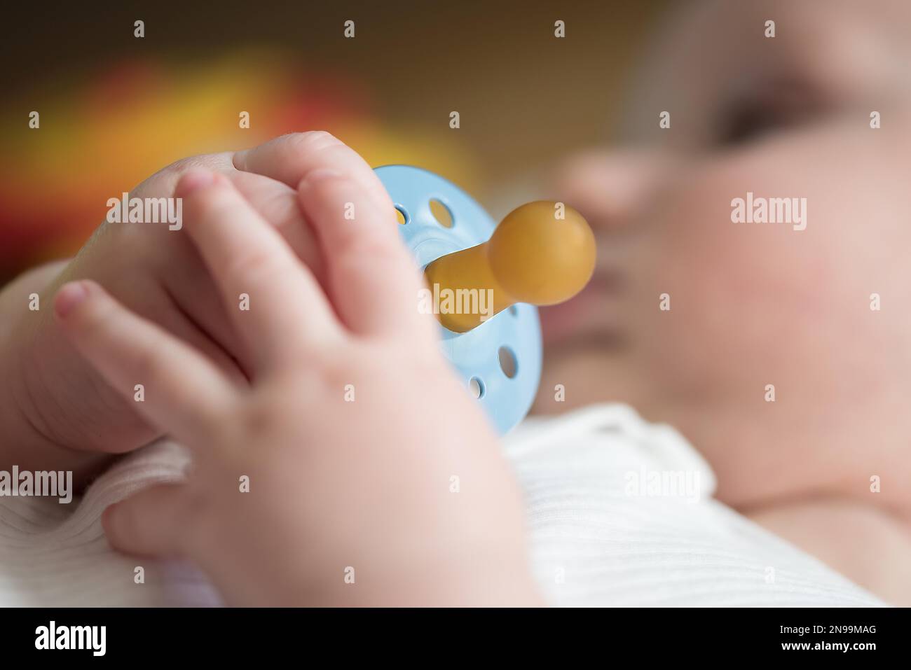 close-up view of hand of baby holding pacifier Stock Photo - Alamy
