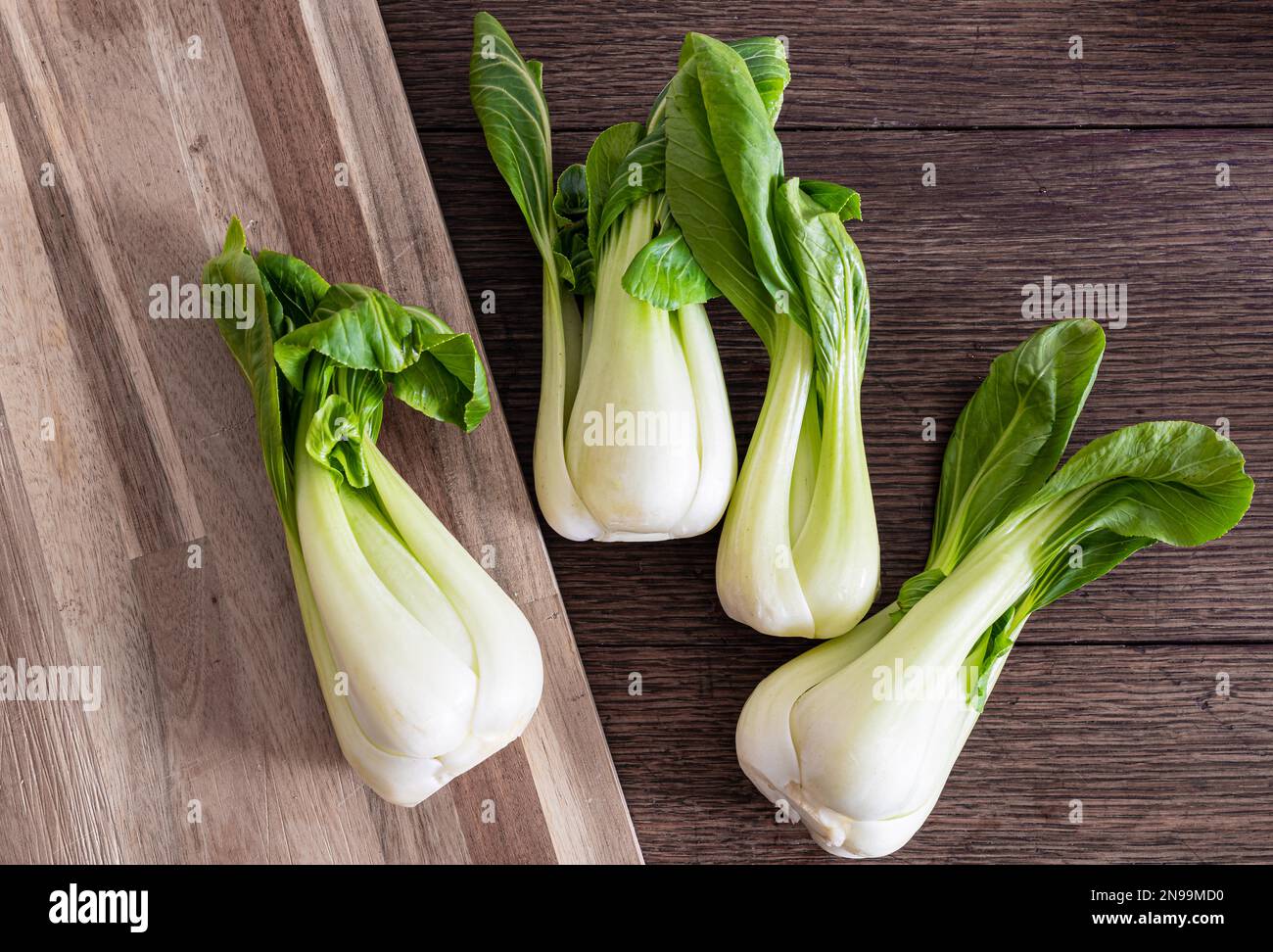 top view of fresh Bok Choy, chinese cabbage, on rustic wooden table ...