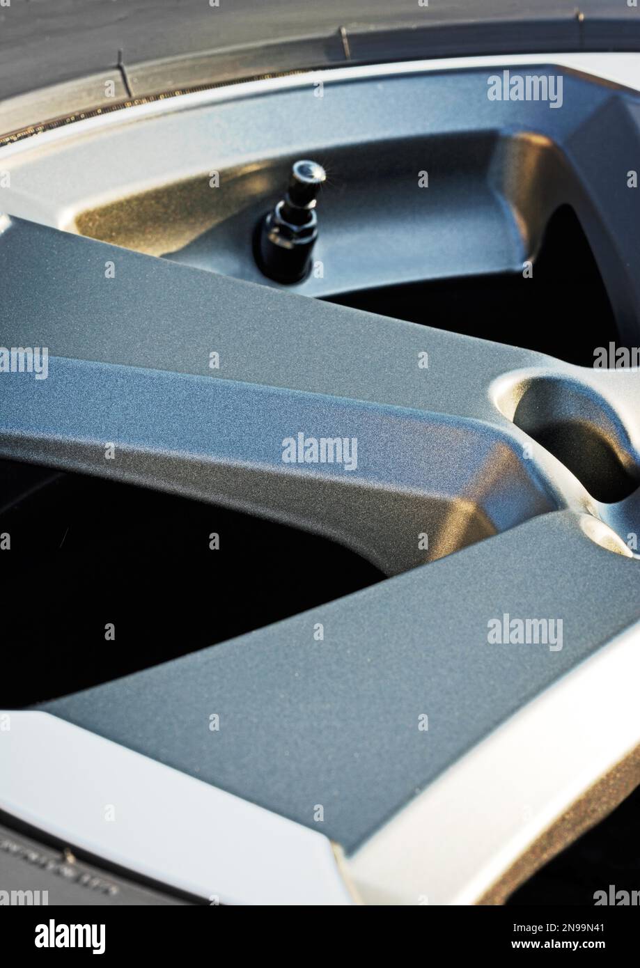 Detail shot of a modern car tyres with aluminium rims and water ...