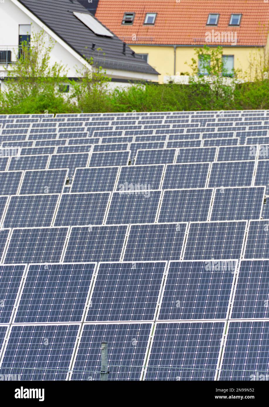 Modern solar power plant on the edge of a residential area, portrait ...