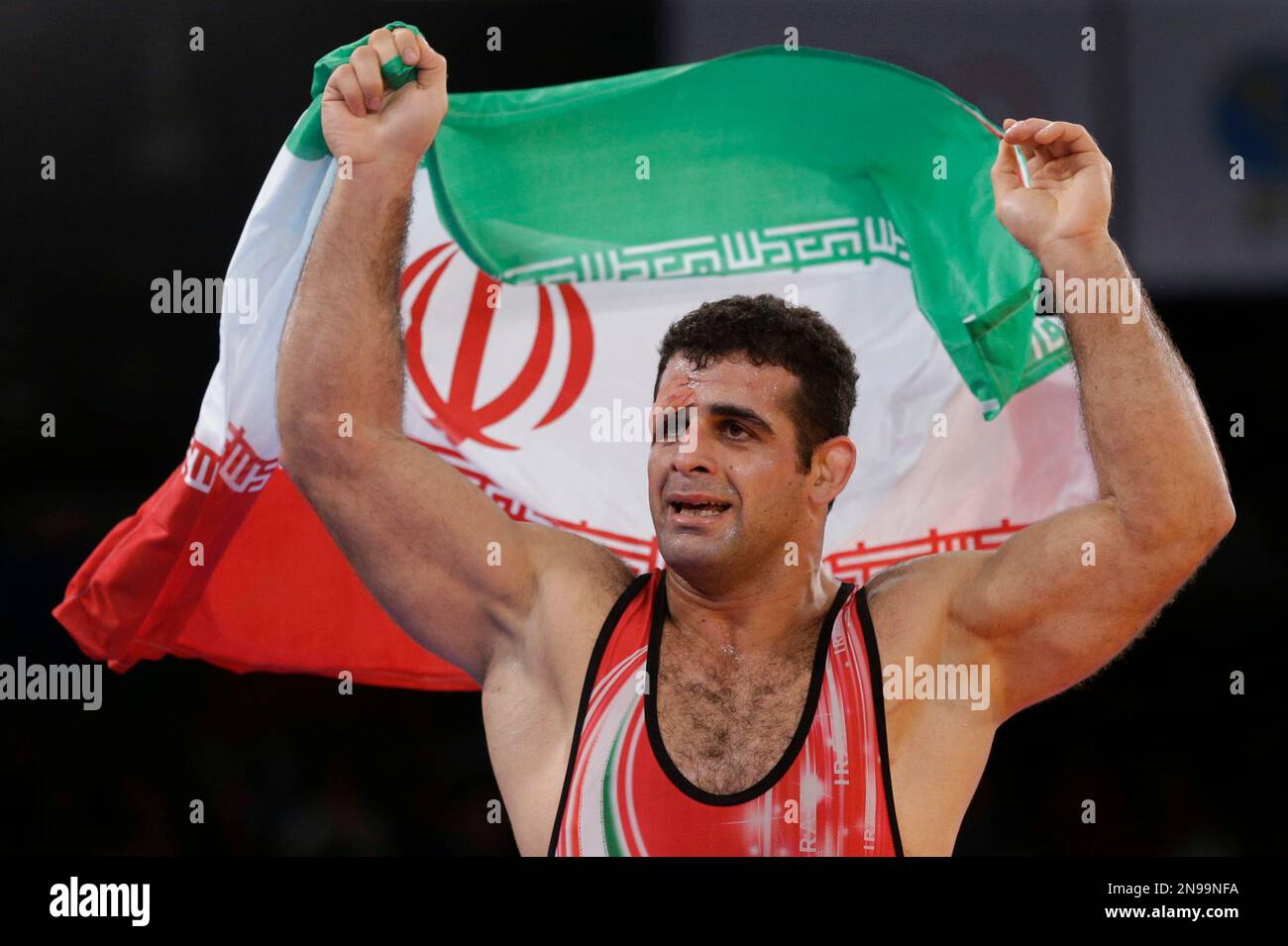Iran's Ghasem Gholamreza Rezaei celebrates after defeating Russia's ...