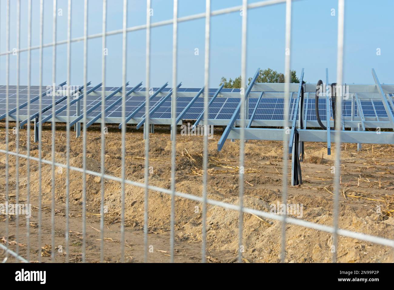 View through fence onto solar park construction site Stock Photo - Alamy
