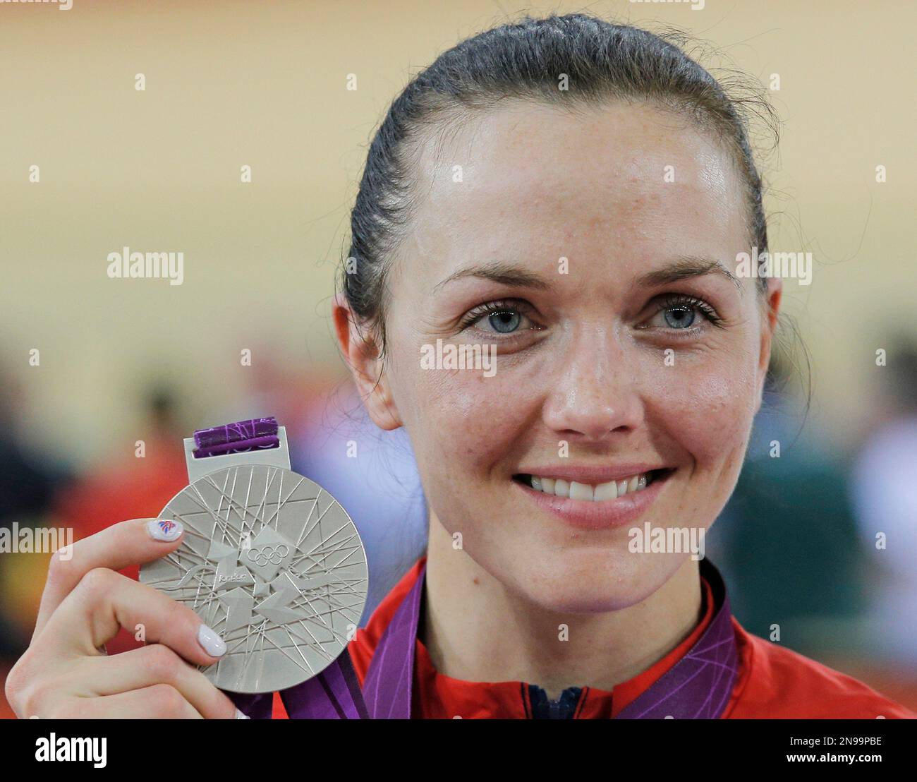 Britain's Victoria Pendleton shows the silver medal she won in the ...