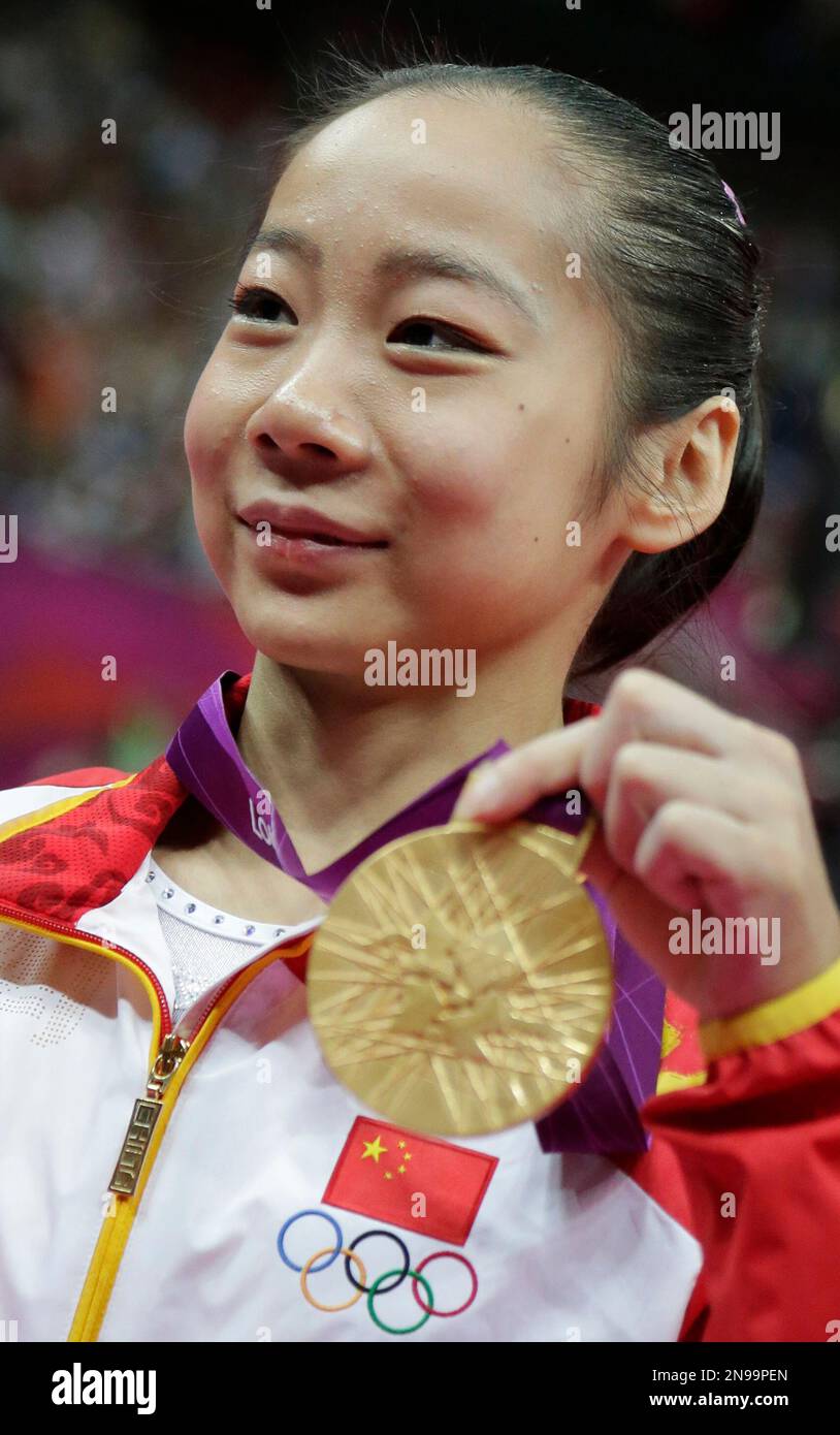 Chinese gymnast Deng Linlin displays her gold medal for the balance ...