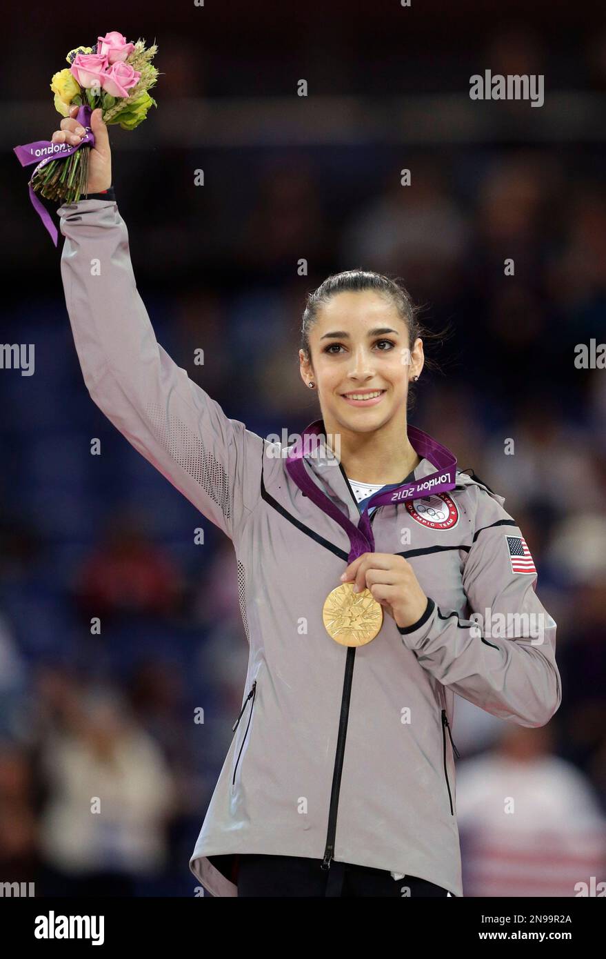 U.S. gymnast Alexandra Raisman displays her gold medal during the ...