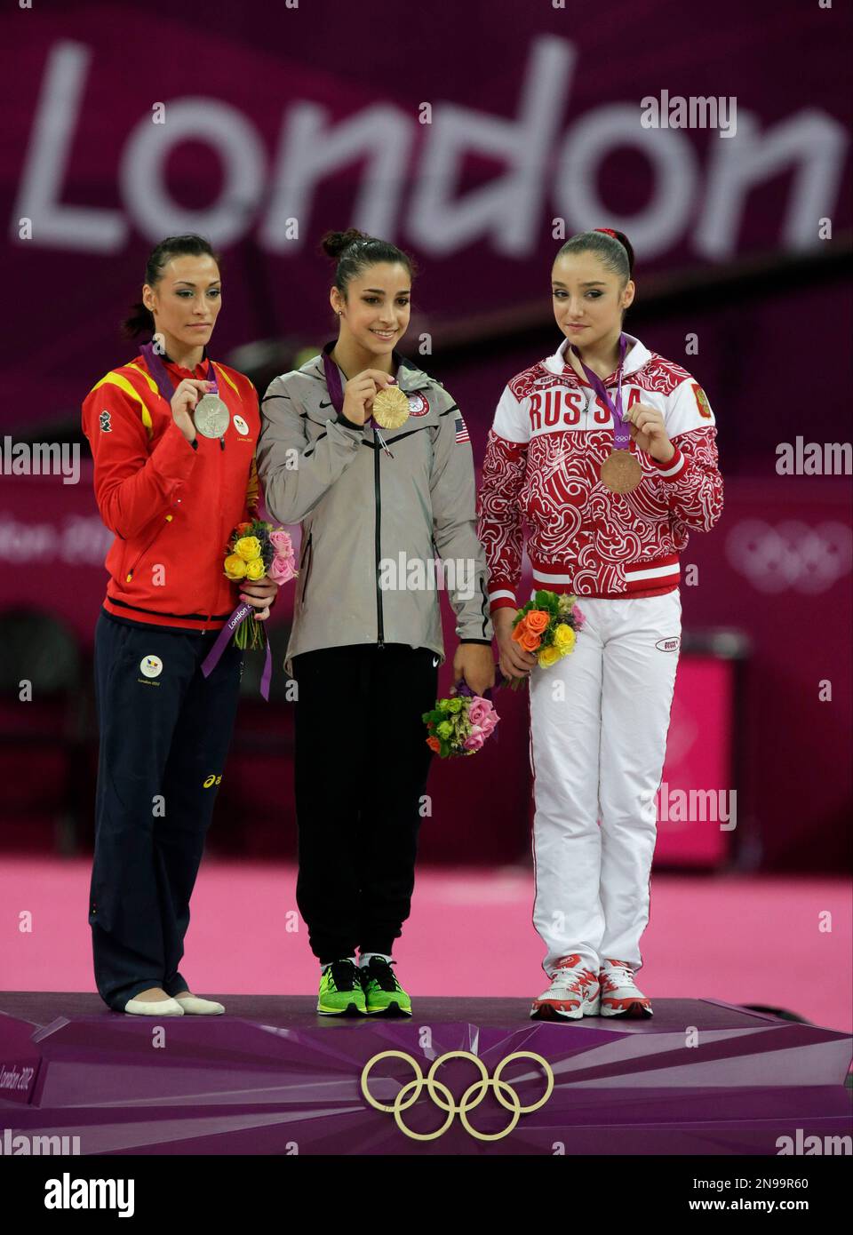 U.S. gold medallist gymnast Alexandra Raisman, center, Romania's silver ...