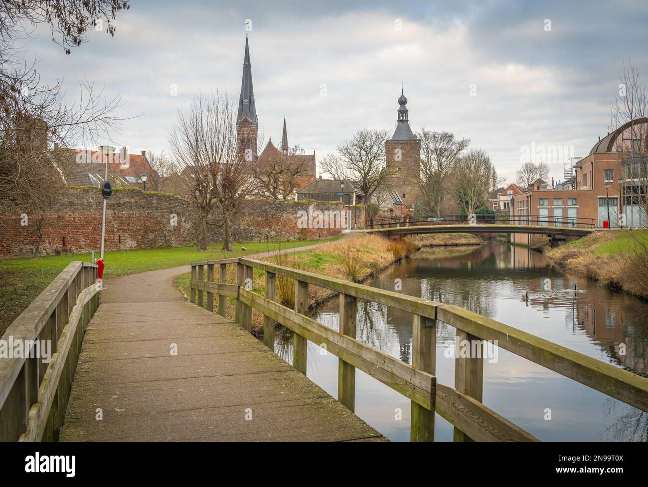 Dutch city of Culemborg, scenery with wooden bridge, old city wall, church and the gate tower ...