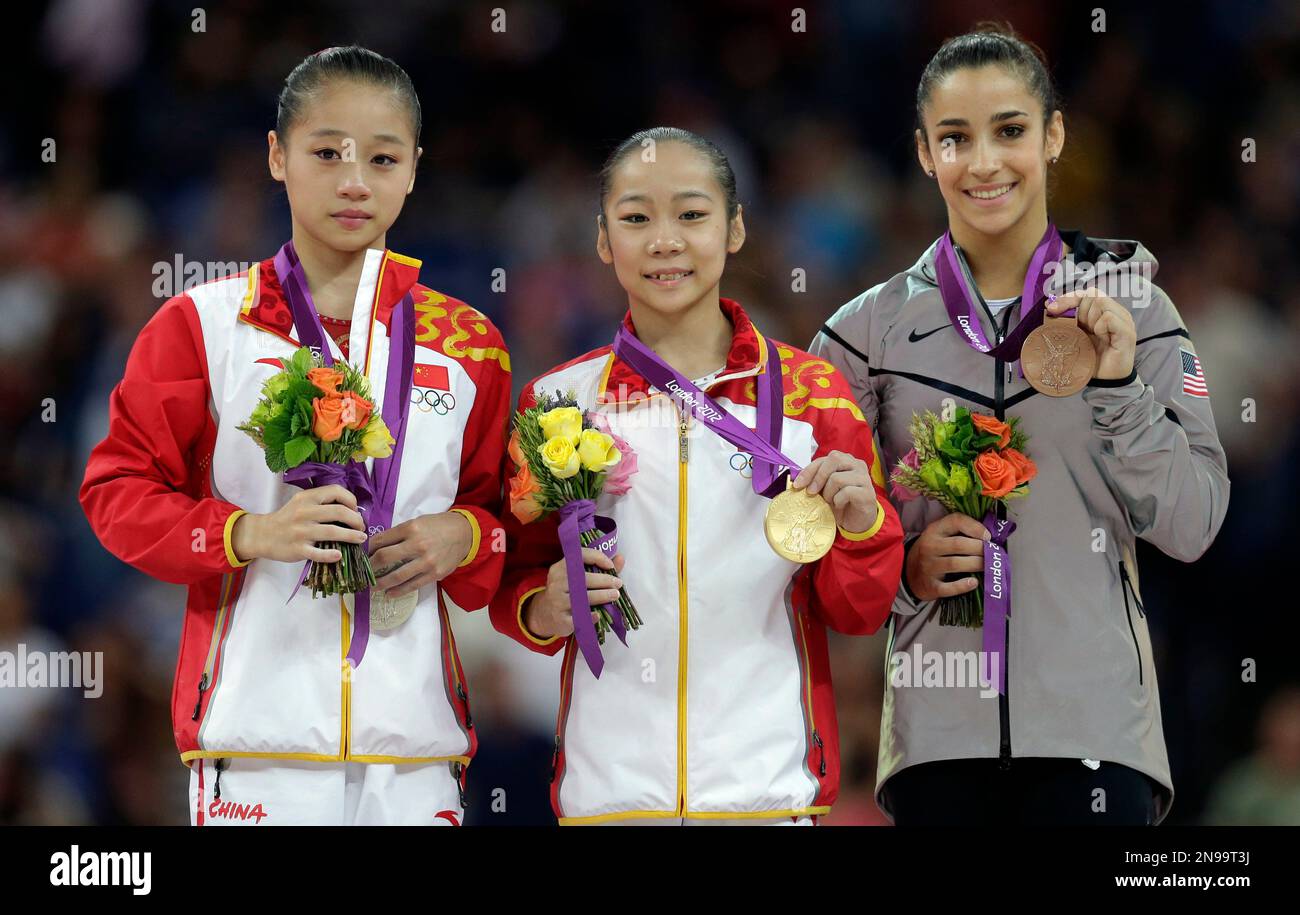 Chinese gold medallist gymnast Deng Linlin, center, silver medallist ...