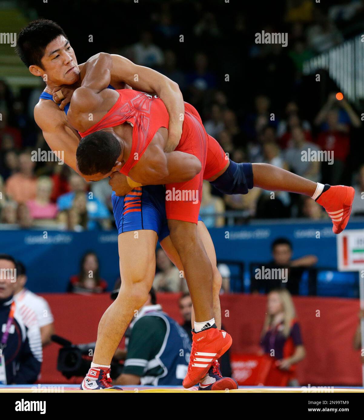 Cuba's Pedro Isaac Mulens Herrera is lifted off the mat by South Korea ...