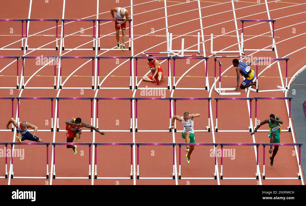 China's Liu Xiang, center, reacts after falling in a men's 110-meter ...