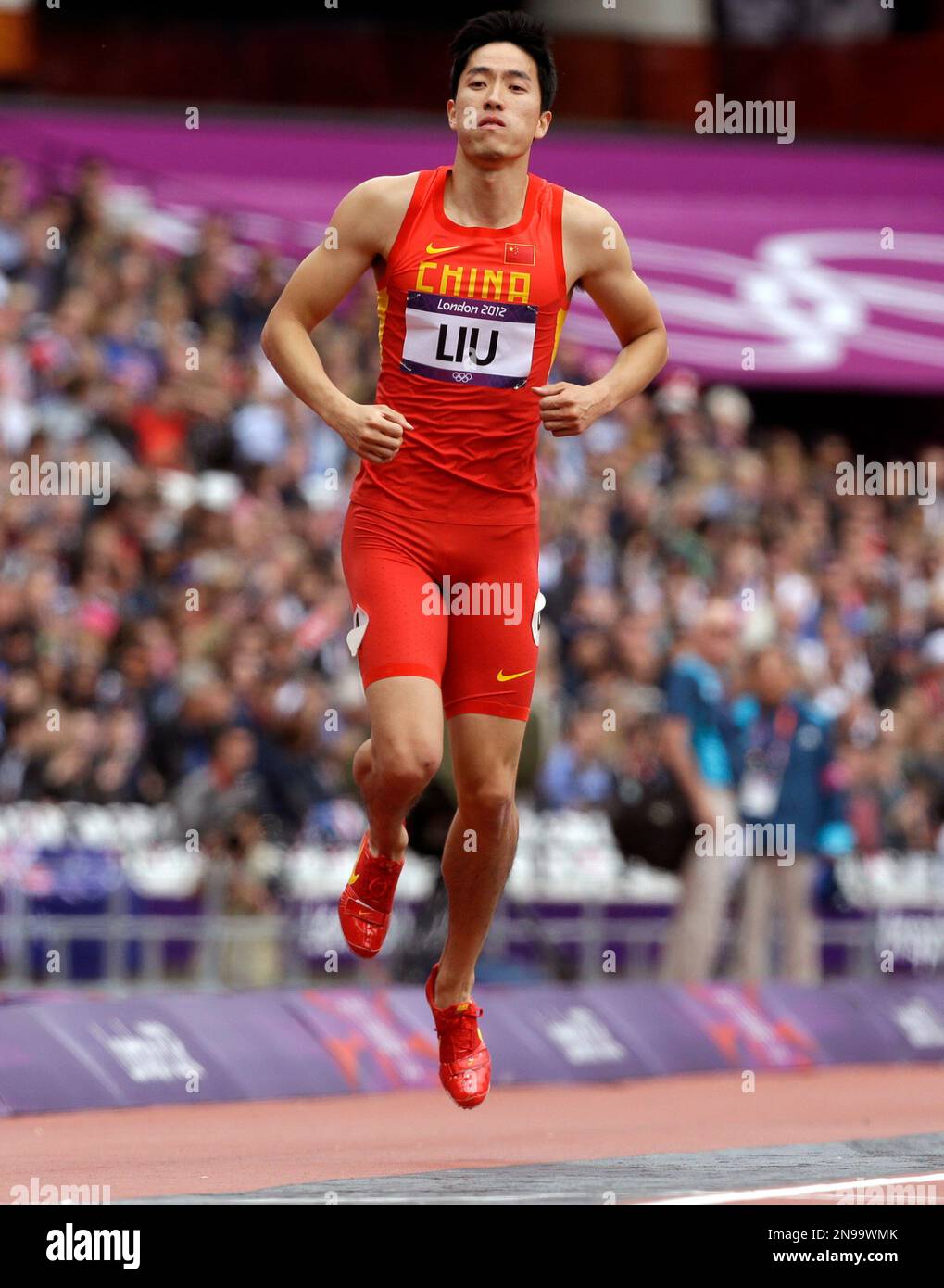 China's Liu Xiang hops off the track after falling in a men's 110-meter ...