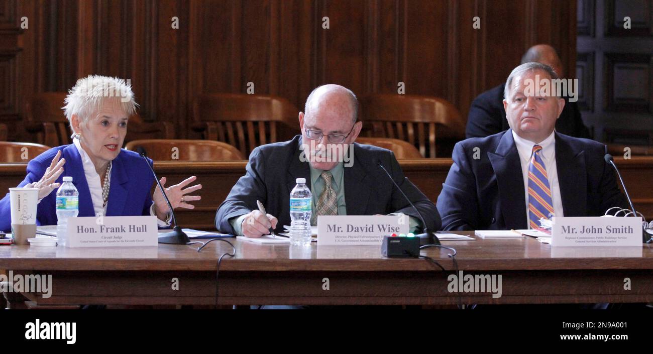 U.S. Circuit Judge Frank M. Hull, left, gestures as she answers a ...