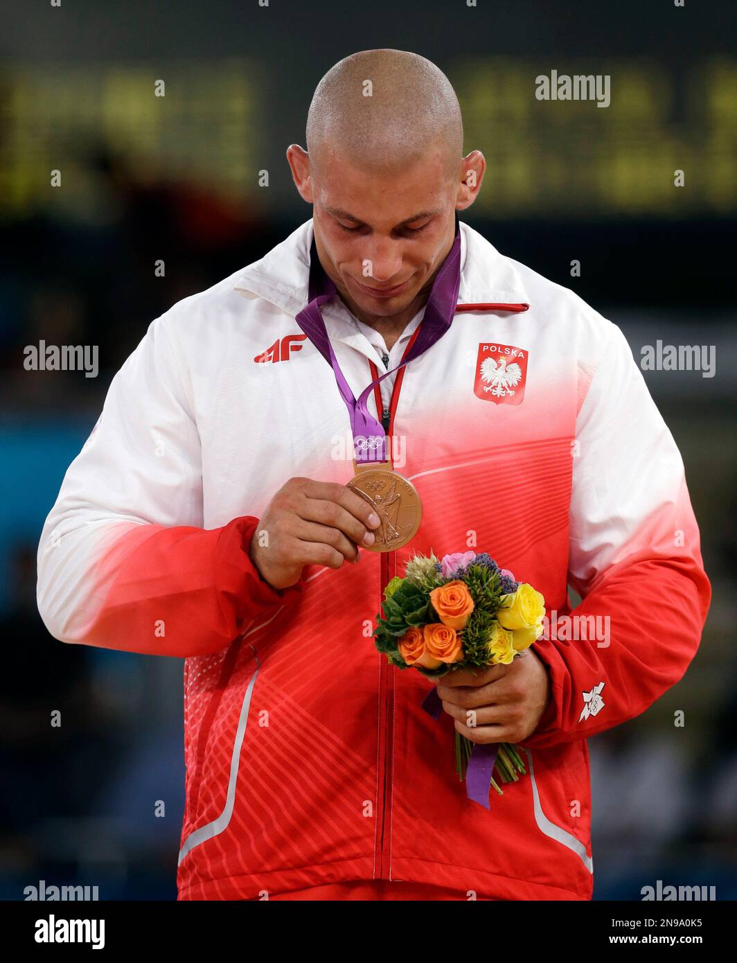 Bronze medalist Damian Janikowski of Poland reacts with his medal ...