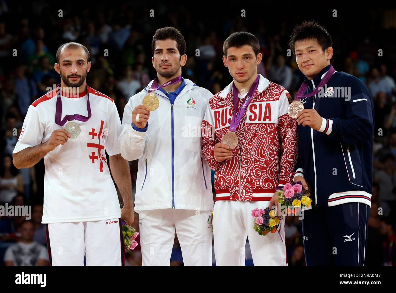 The medalists show the medals after the victory ceremony for the 60-kg ...