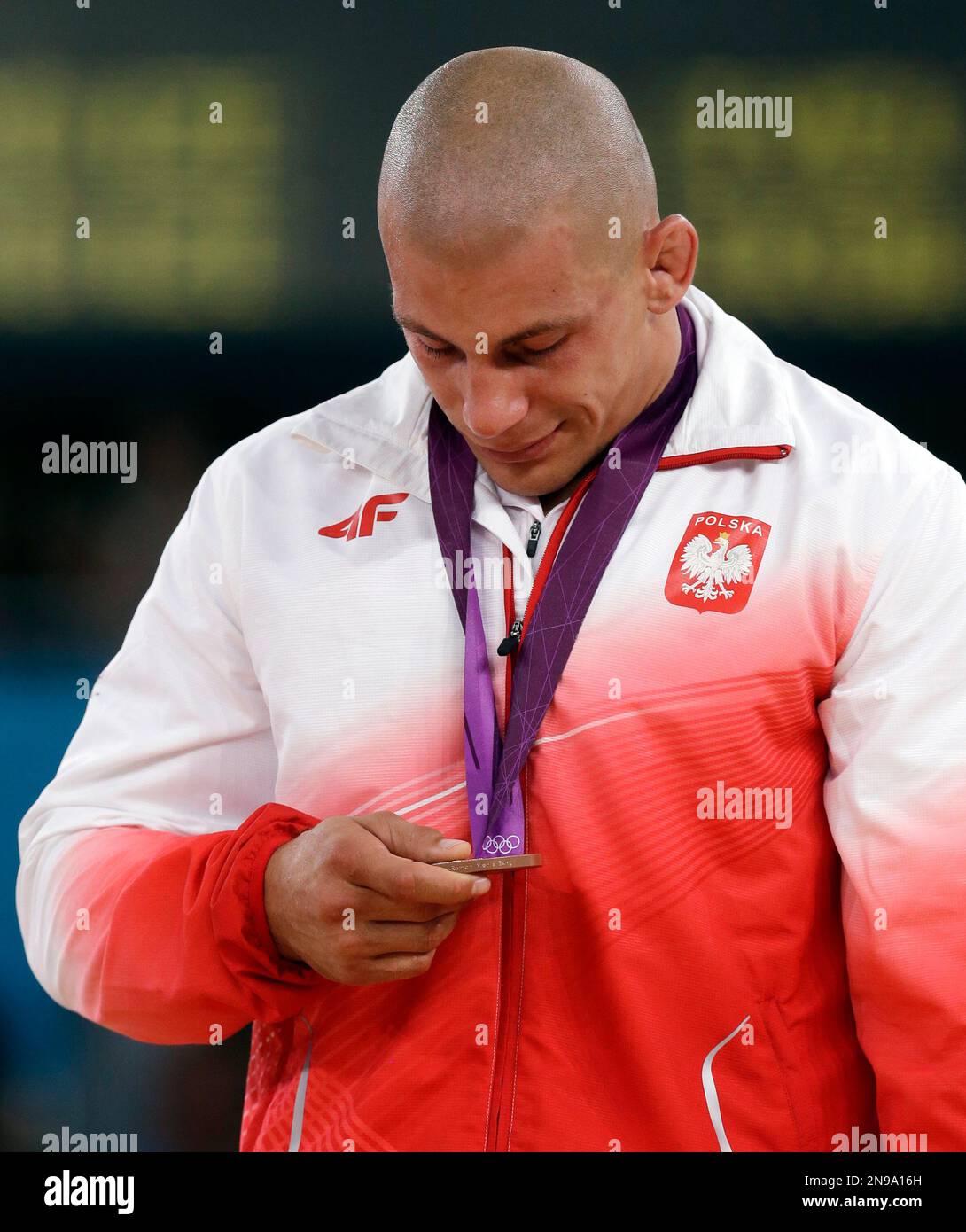 Bronze medalist Damian Janikowski of Poland reacts with his medal ...