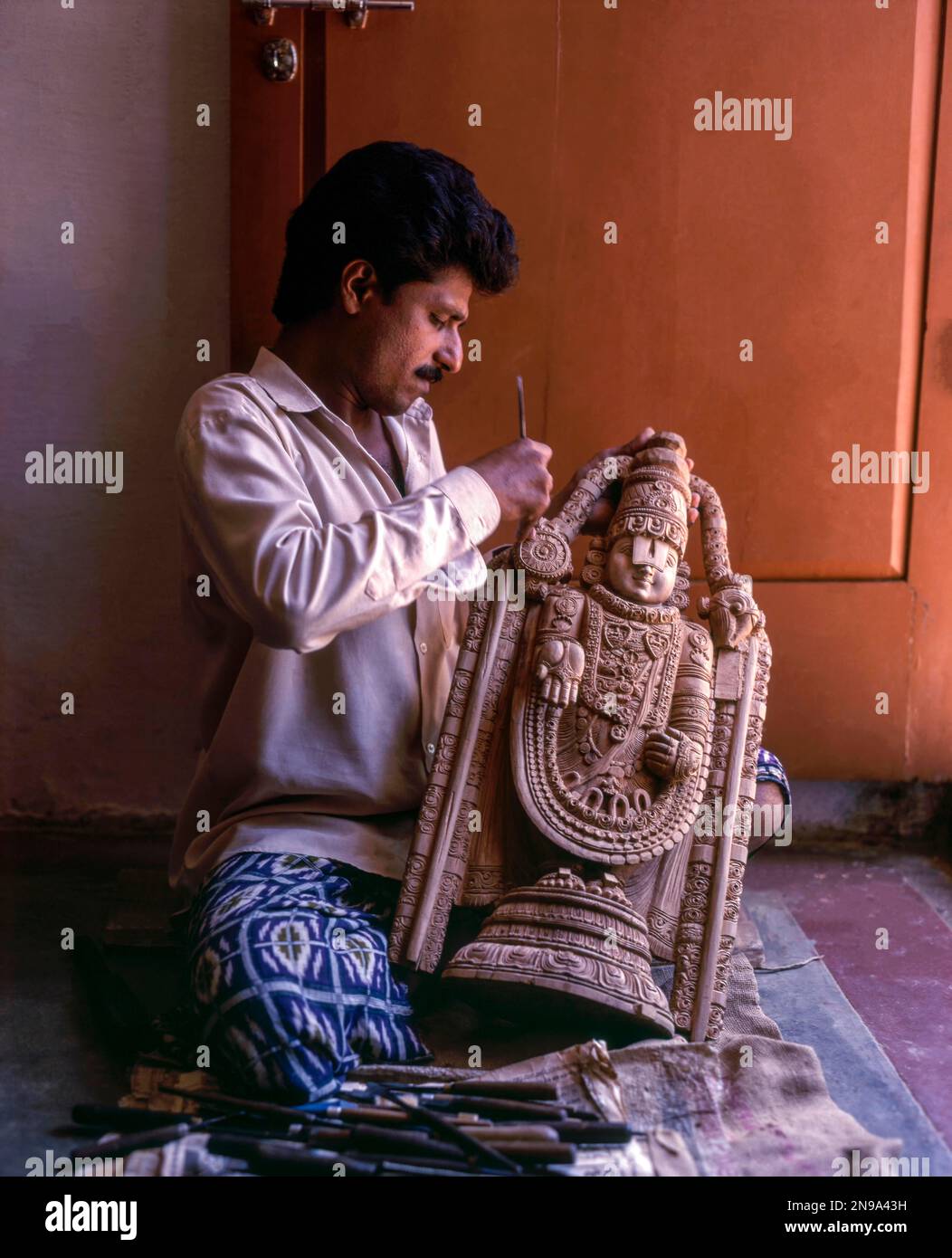 A craft man with his sandalwood Balaji or Vishnu in Mysuru or Mysore ...