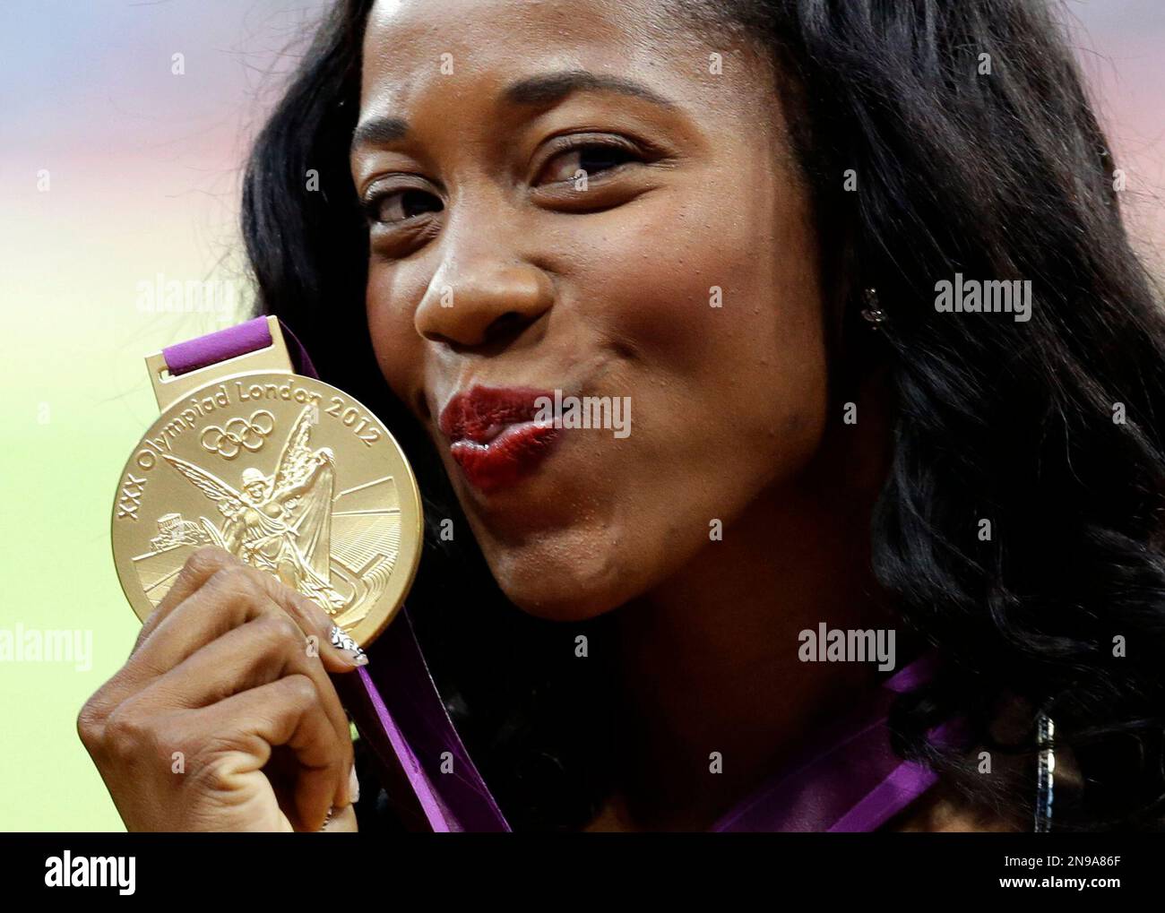 Jamaica's Shelly-Ann Fraser-Pryce holds her gold medal for the women's 100-meters during the ...