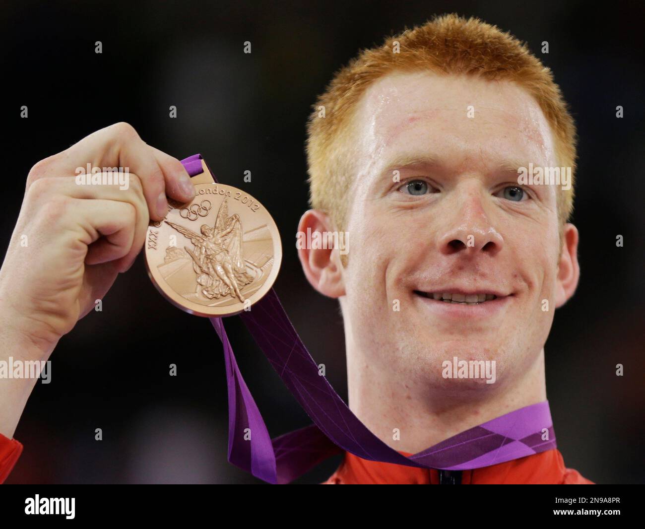 Edward Clancy of Britain shows of his bronze medal in the track cycling ...