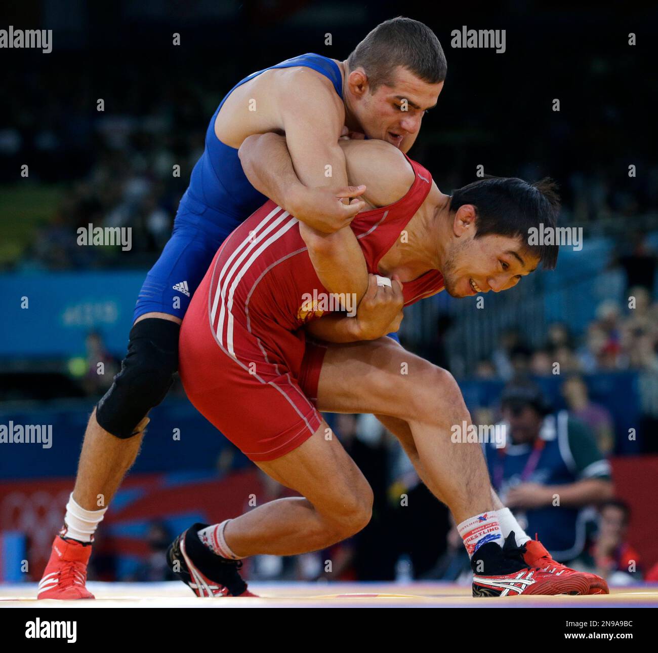 Kyrgyzstan's Arsen Eraliev competes with Hungary's Peter Modos, left ...