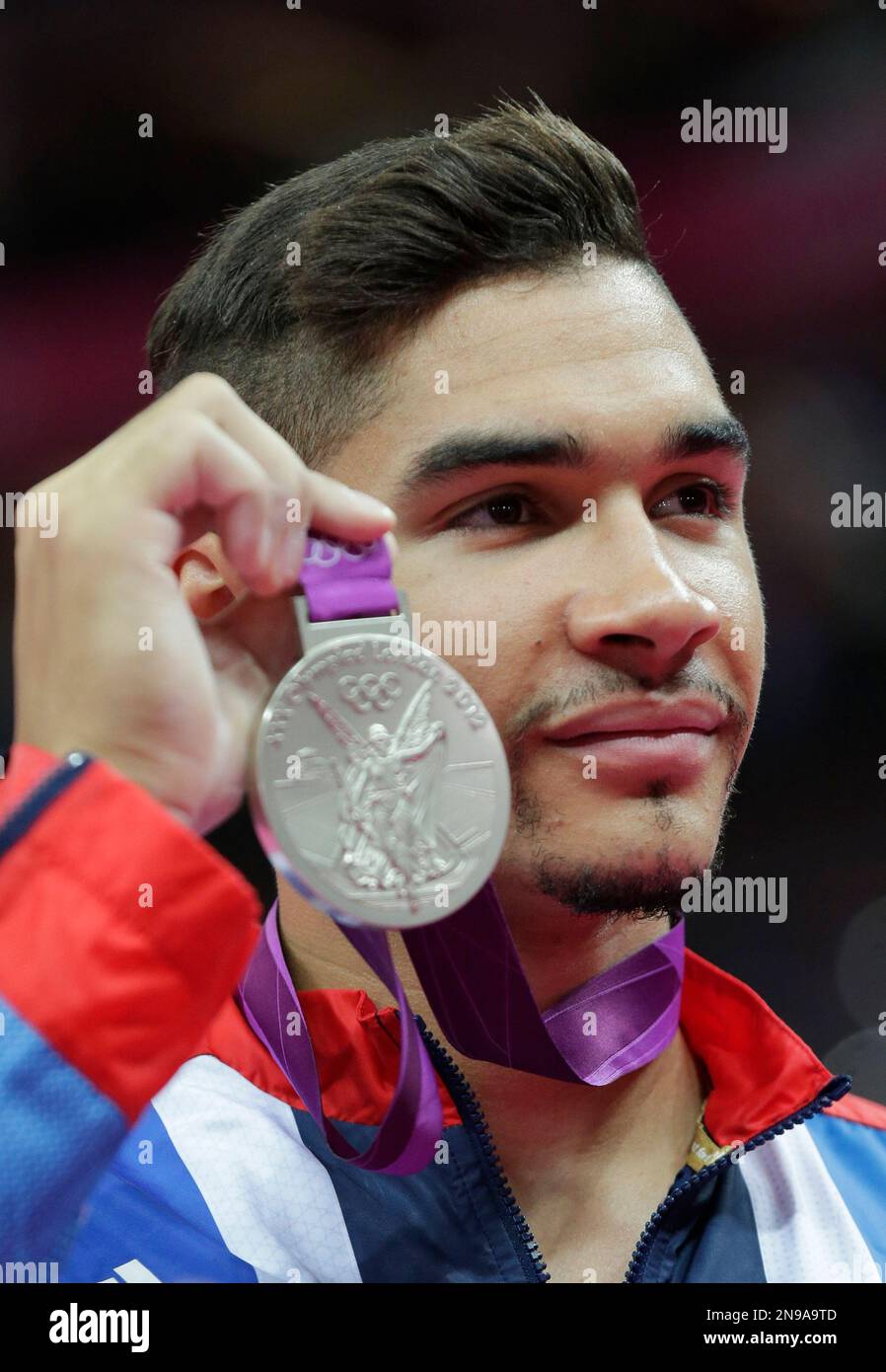 Britain's gymnast Louis Smith displays his silver medal during the ...